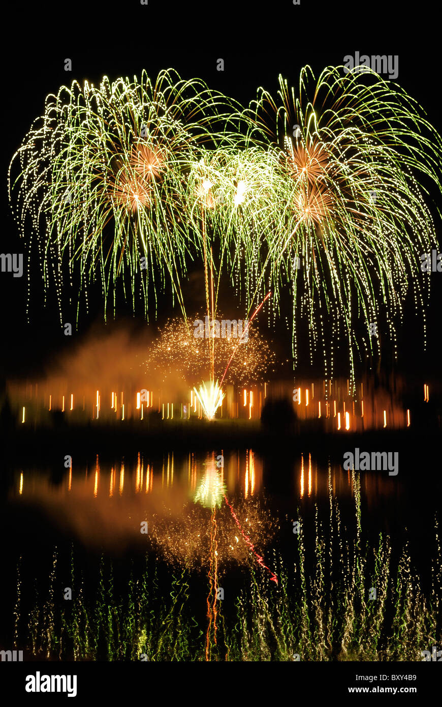 night traditional firework with reflection in water Stock Photo - Alamy