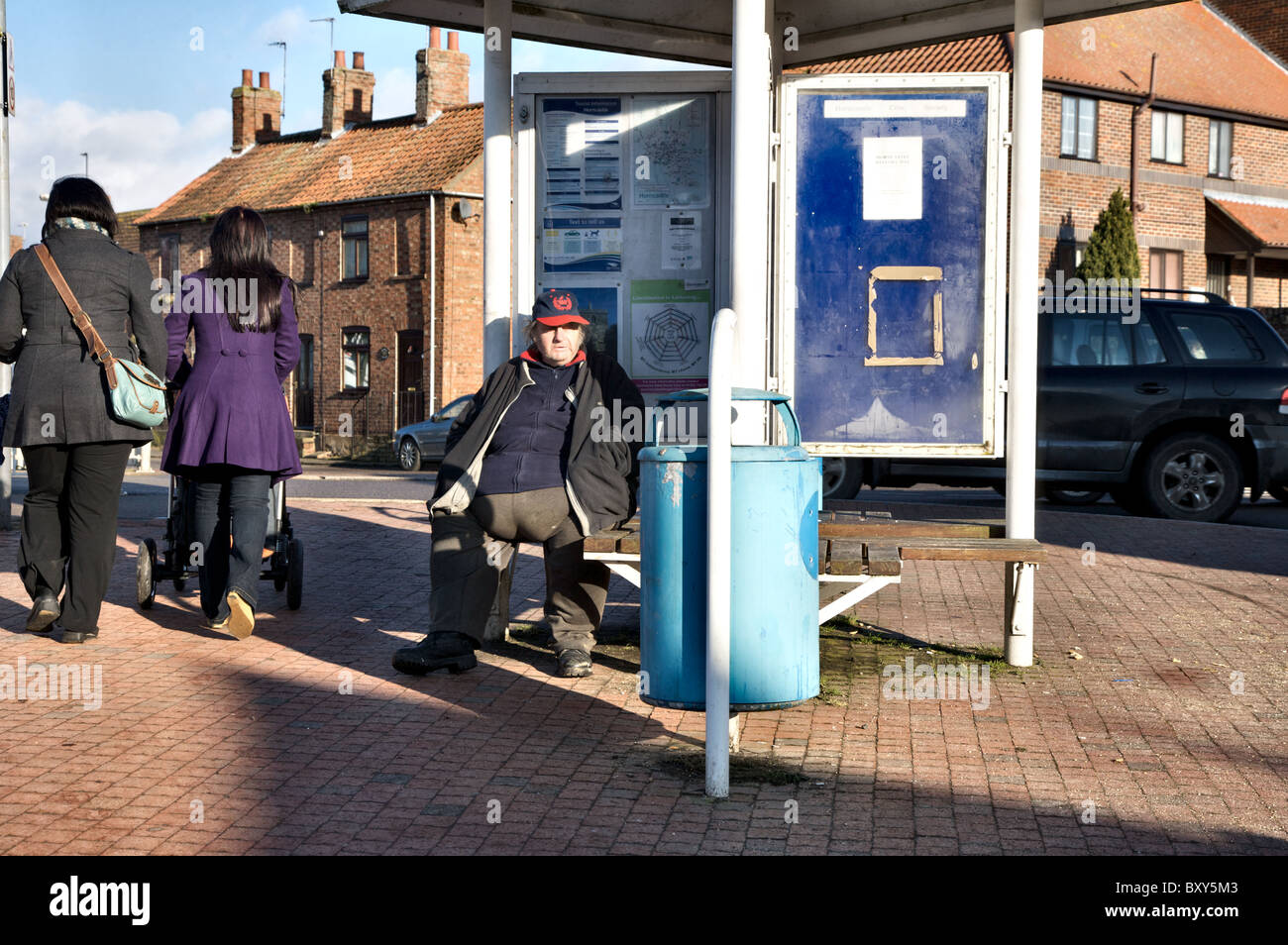 Obese man at bus stop Stock Photo - Alamy