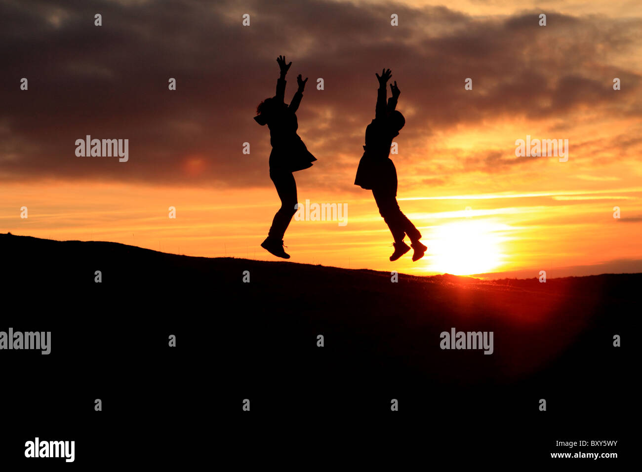 Jumping at Sunset Stock Photo - Alamy