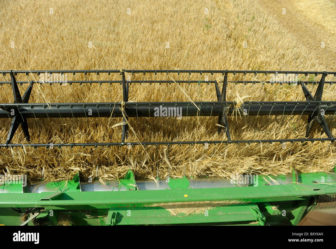 A John Deere combine harvester harvesting barley in a field at Holme ...