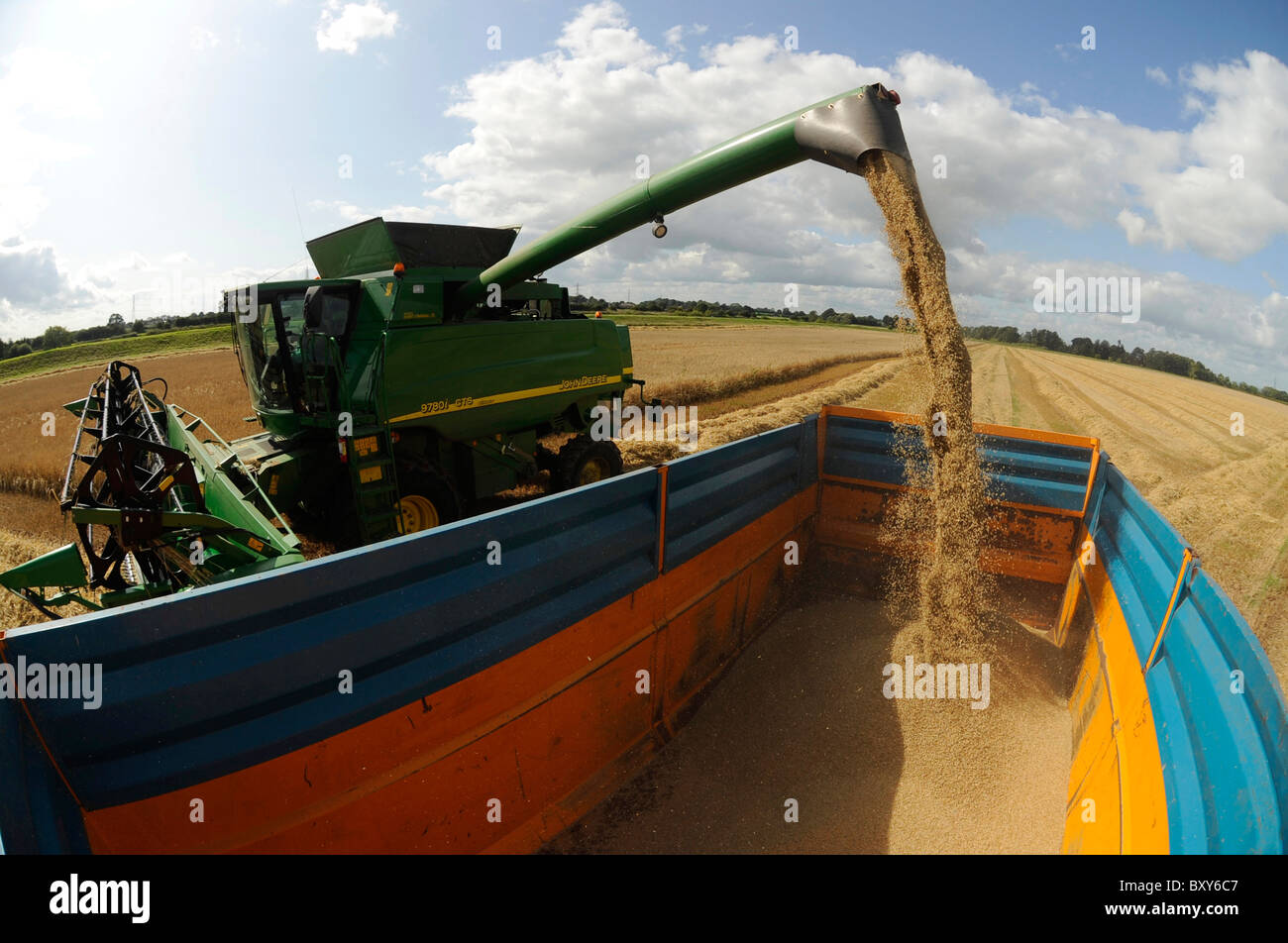 A John Deere combine harvester harvesting barley in a field at Holme ...