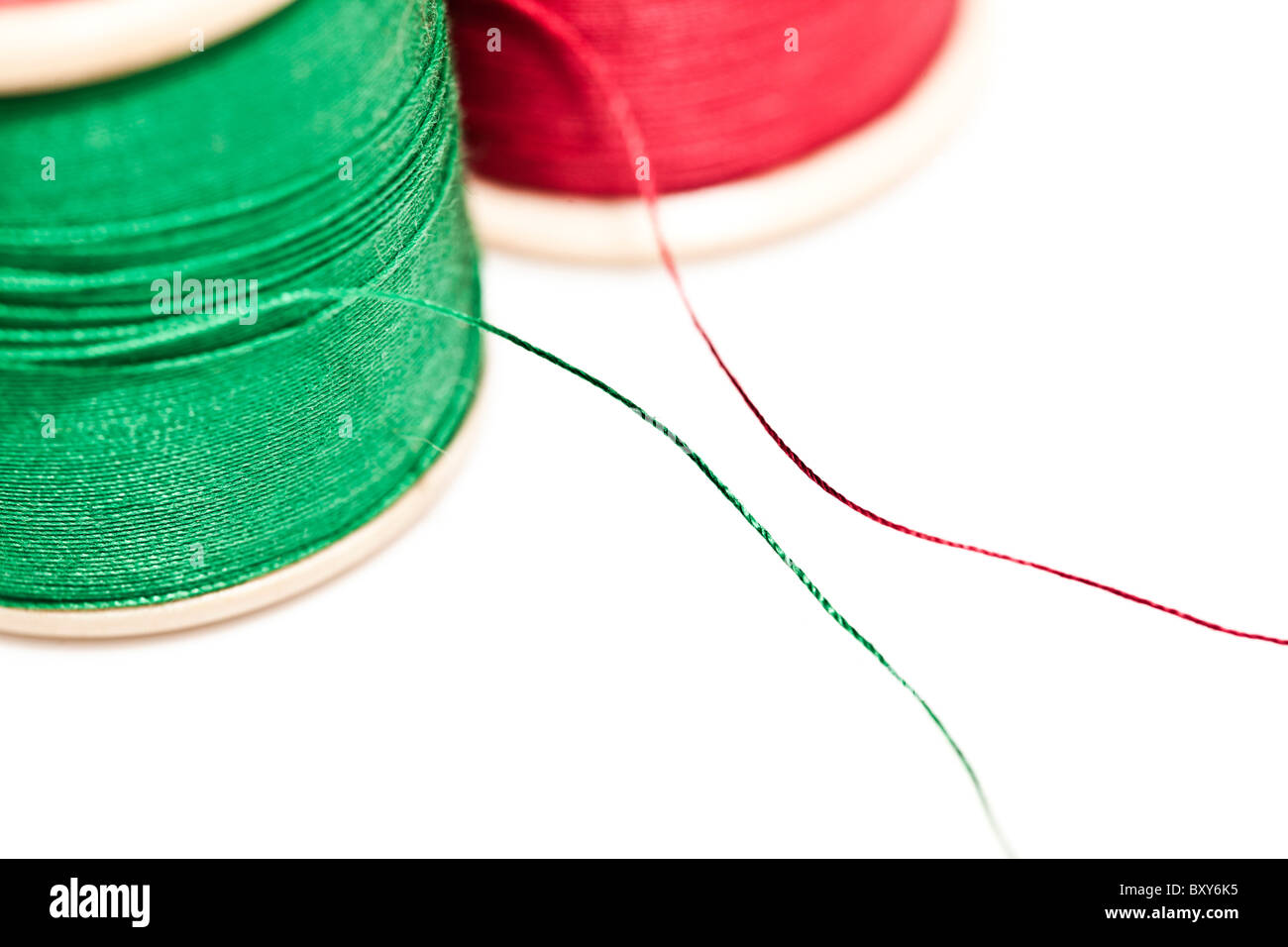two reels of cotton in red and green Stock Photo - Alamy