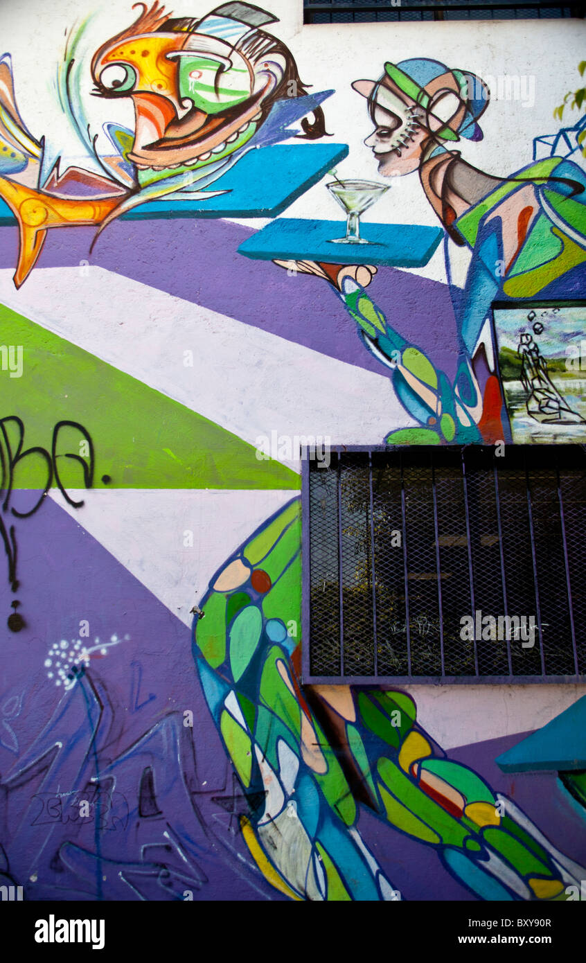 Abstract wall mural depicting a fish & woman along a street in the ...