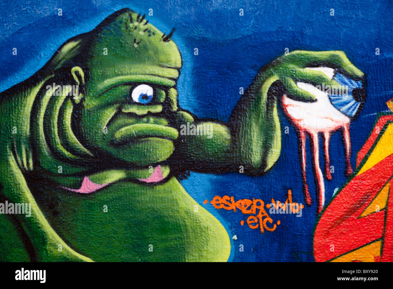 Wall mural depicting a green monster along a street in the Spanish ...