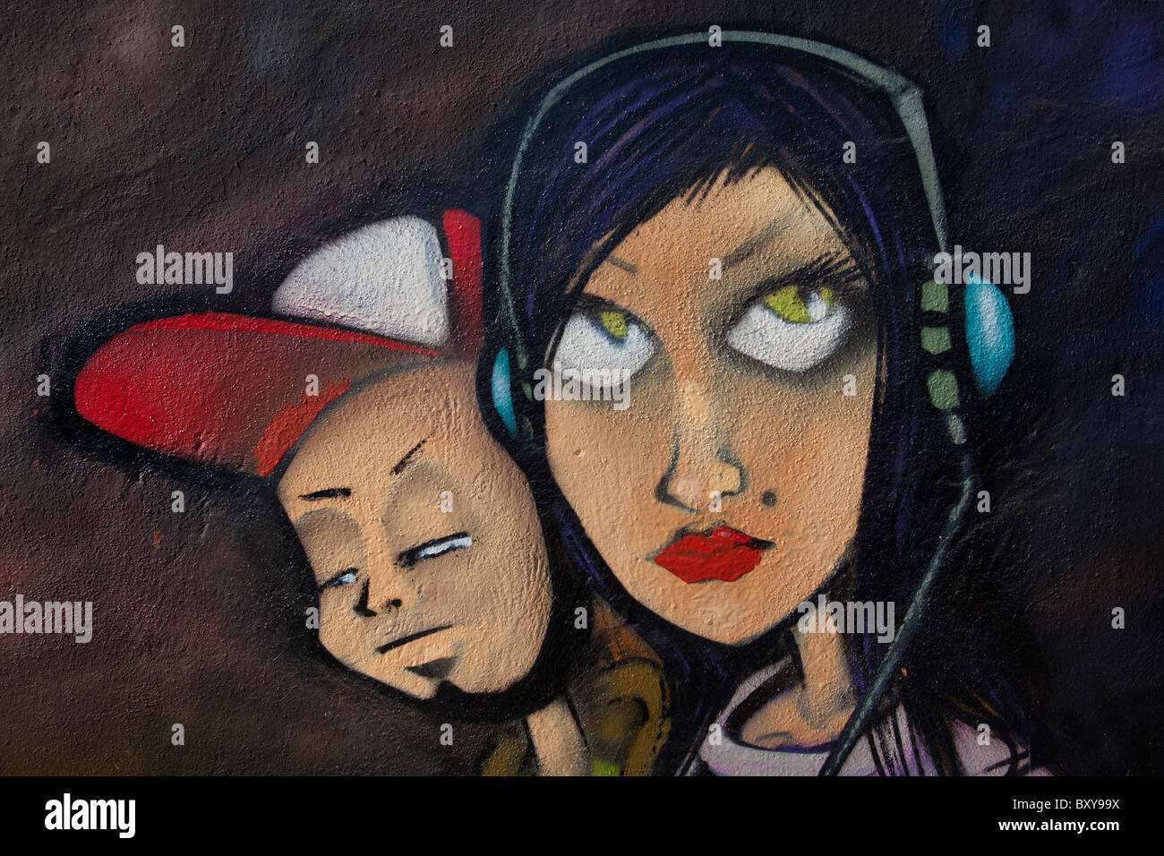 Wall mural depicting a young girl & child along a street in the Spanish ...