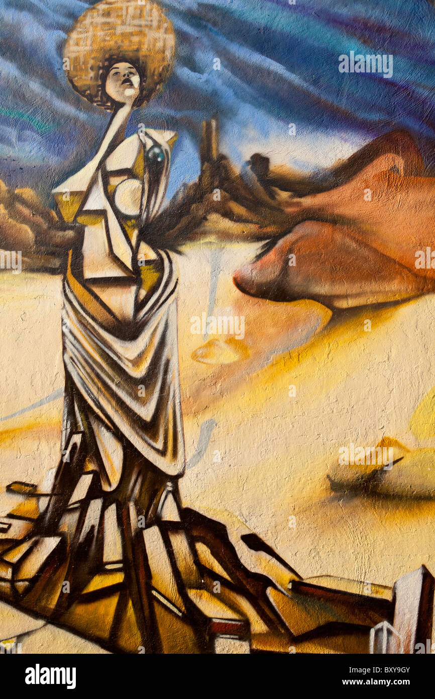 Abstract wall mural depicting a young woman along a street in the ...