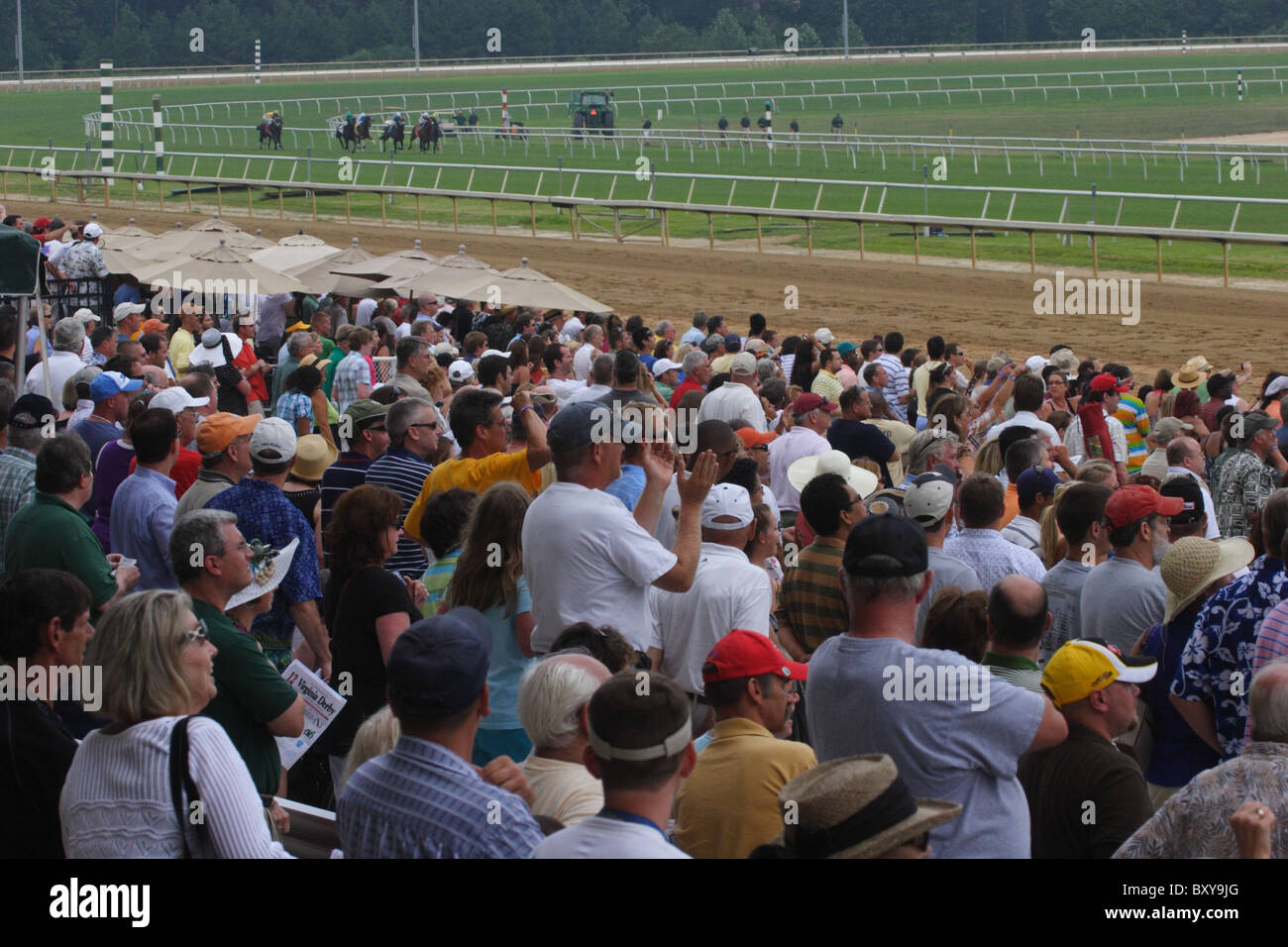 Crowd cheering as horses approach finish line at Colonial Downs ...