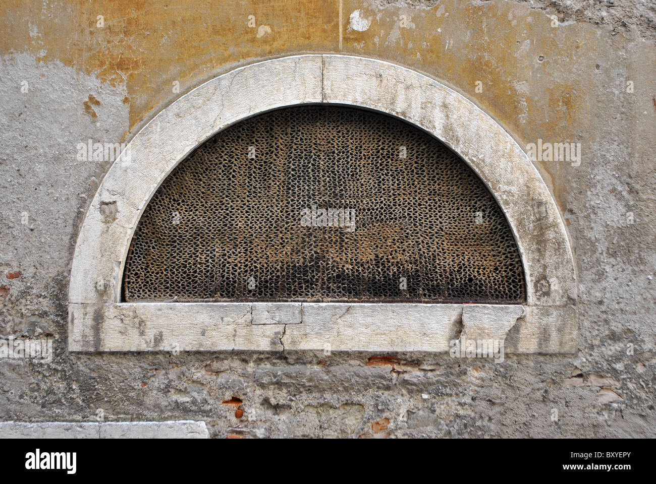crescent-shaped window with safety net and the wall crumbling Stock ...