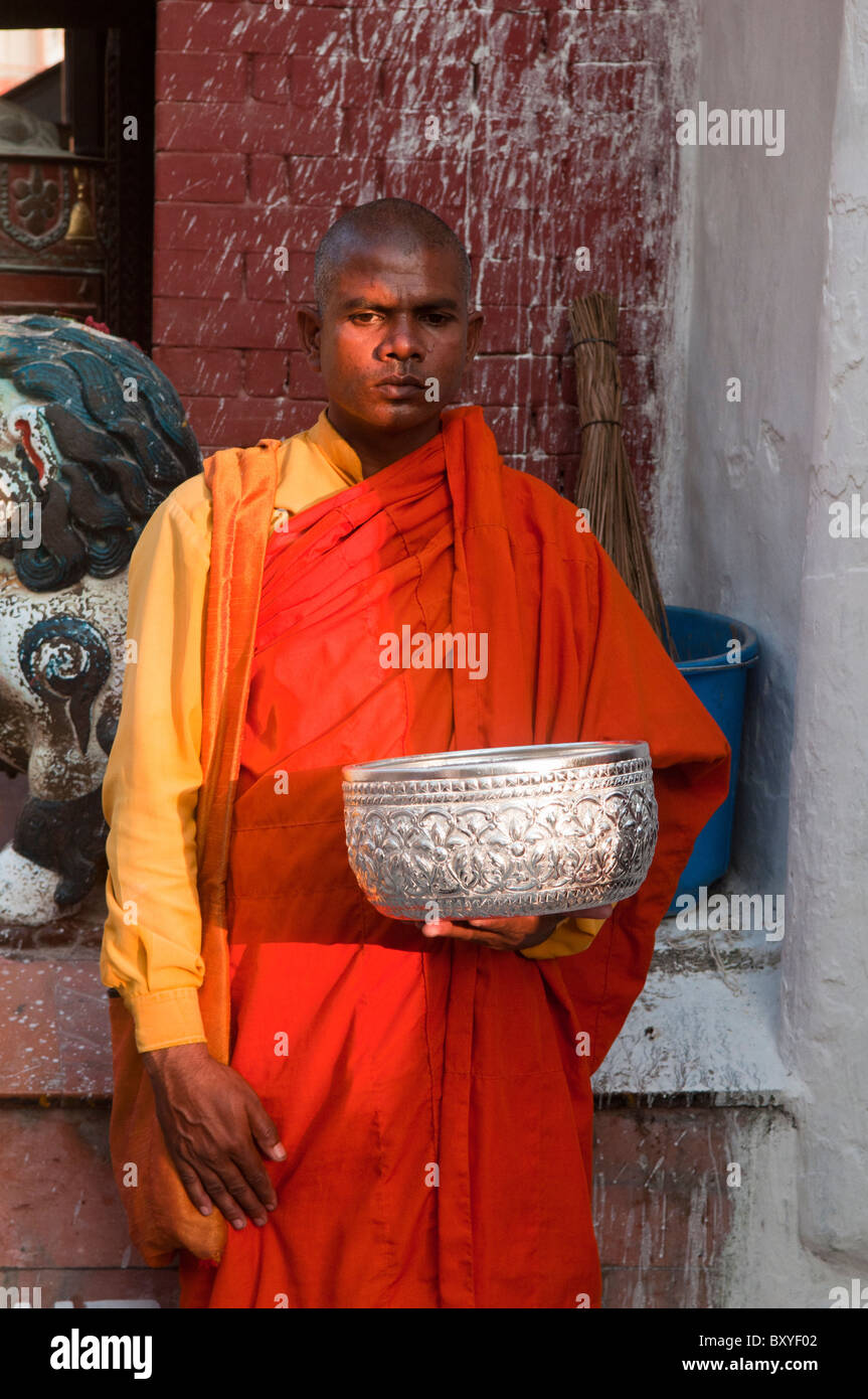 monk begging for alms at the Buddhist stupa of Boudhanath in Kathmandu ...