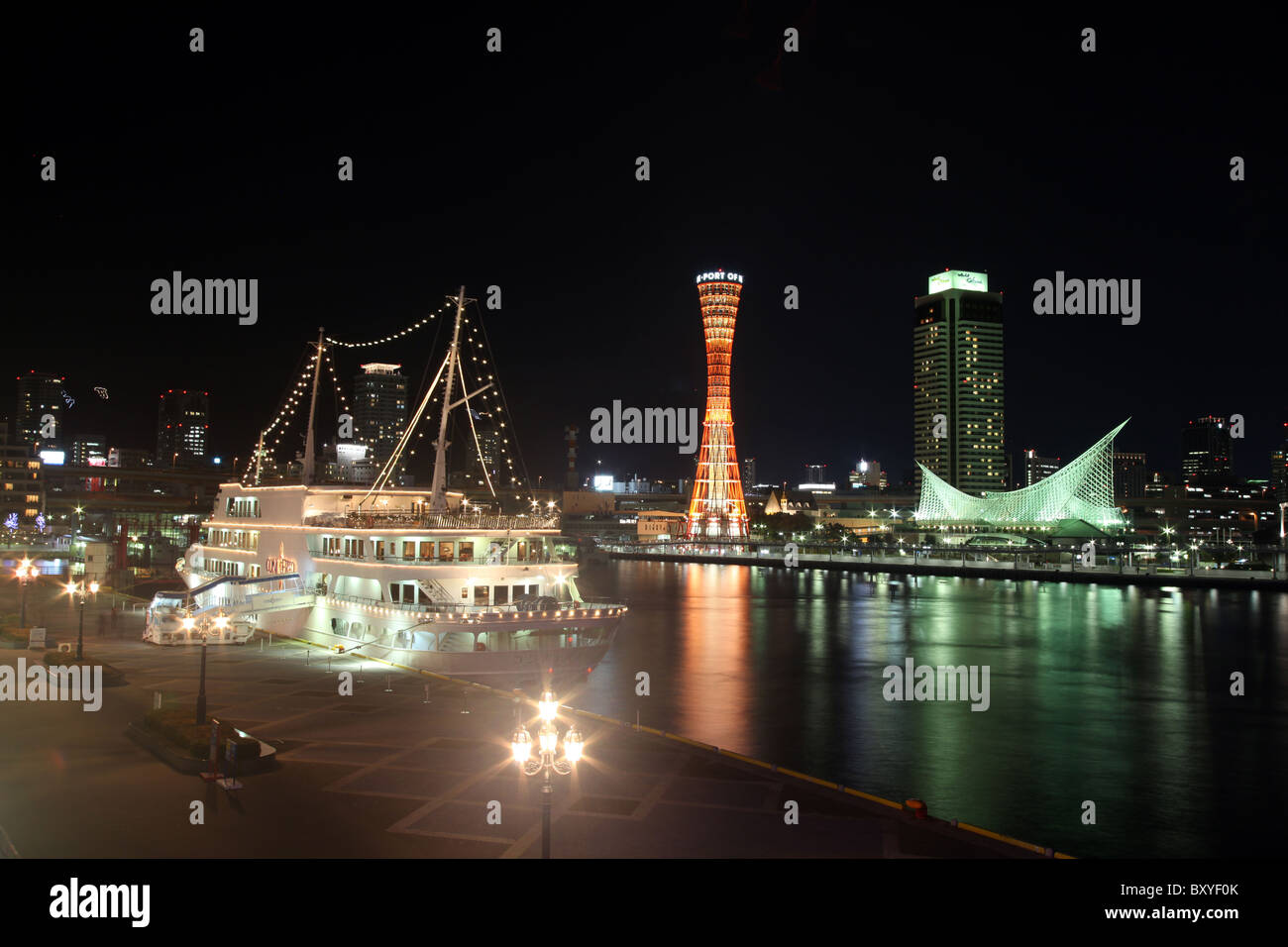 Night view of Kobe Harbour with large ship, port tower and maritime ...