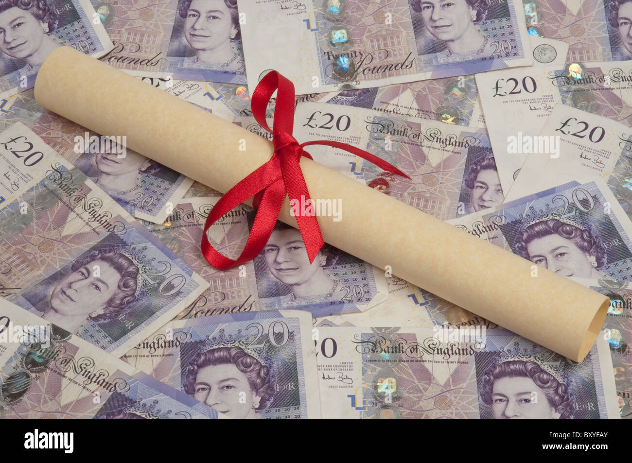 Degree certificate on a background of twenty pound notes Stock Photo ...