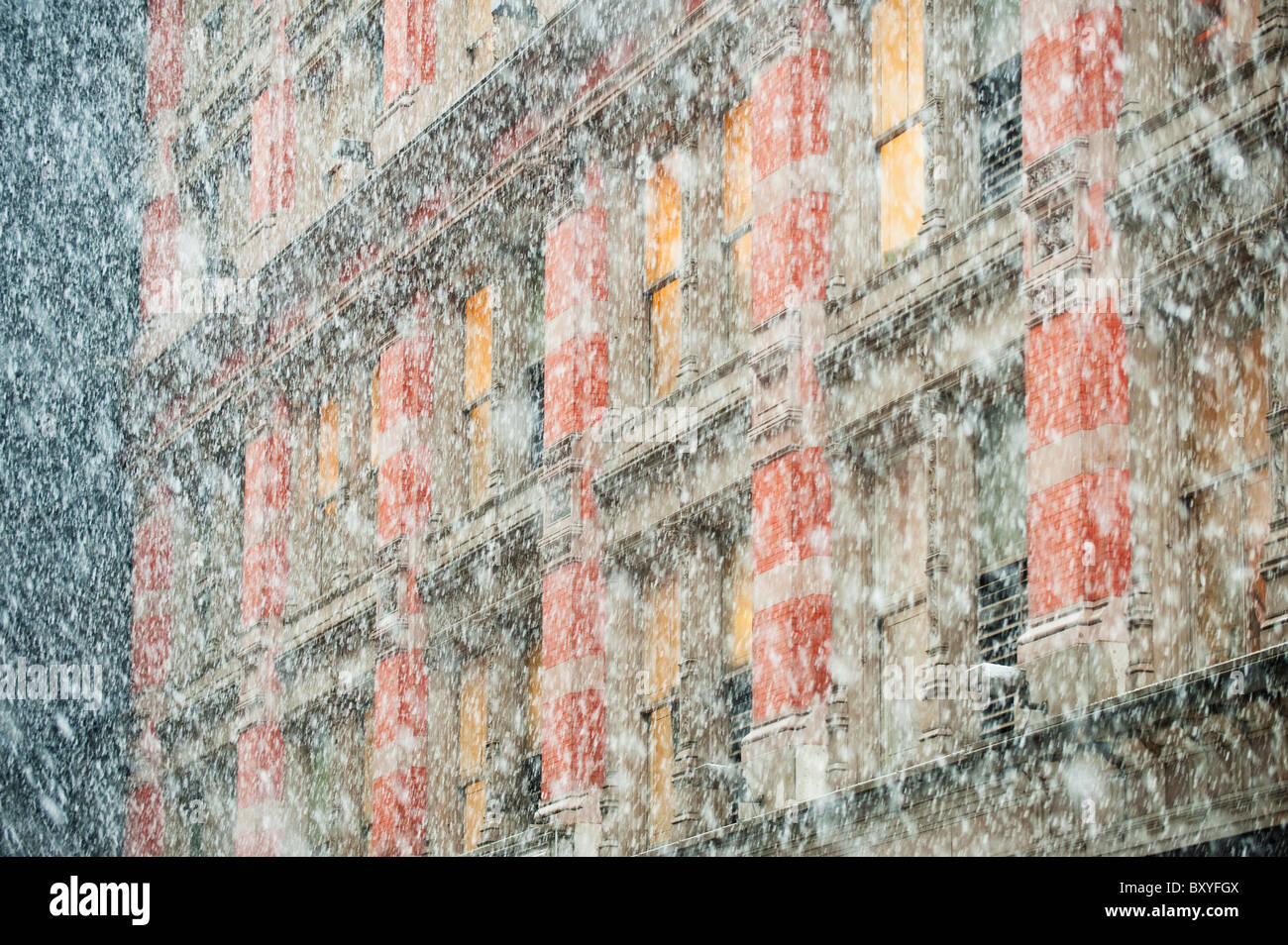 Snow falling in front of apartment building Stock Photo - Alamy