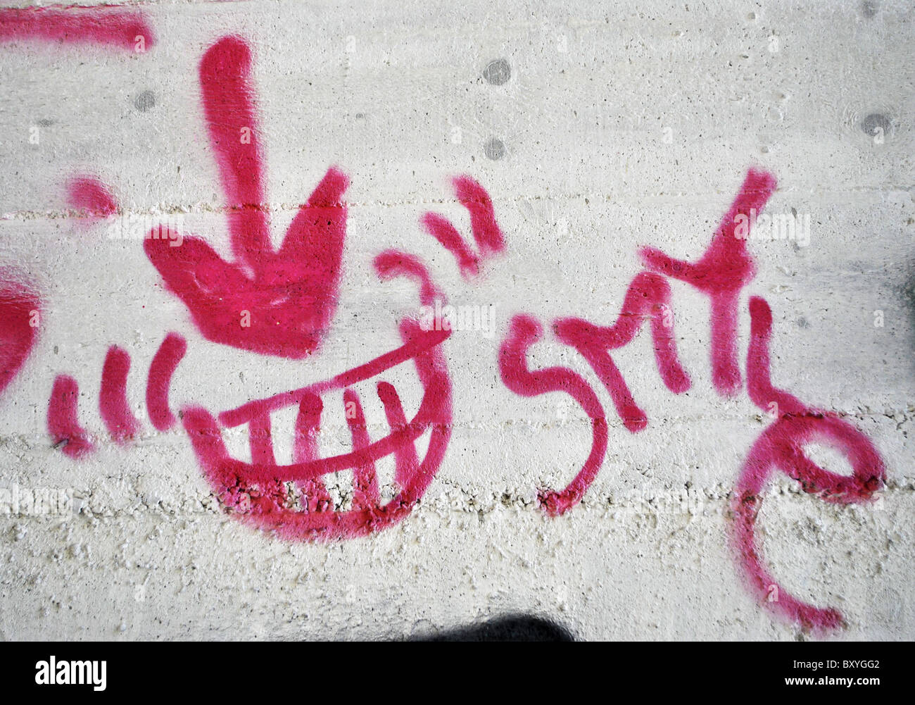 graffiti on the concrete wall written smiley Stock Photo - Alamy