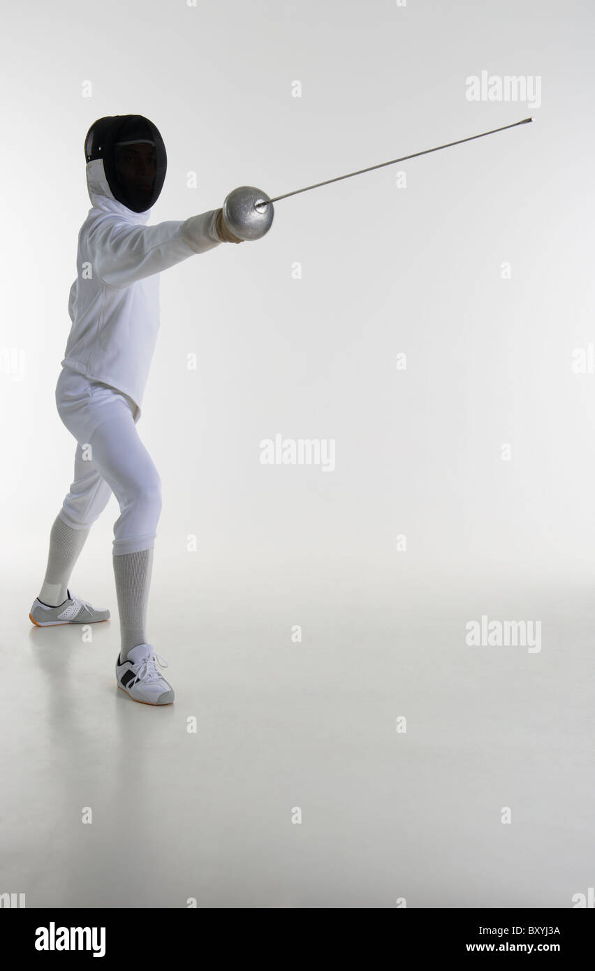Studio portrait of fencer holding fencing foil Stock Photo - Alamy