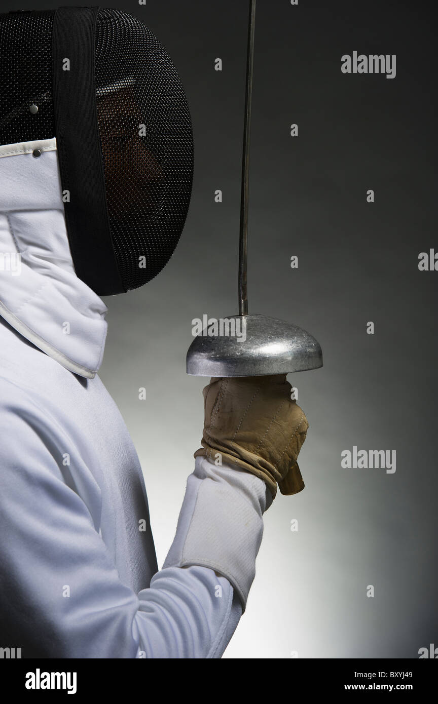 Studio portrait of fencer holding fencing foil Stock Photo - Alamy