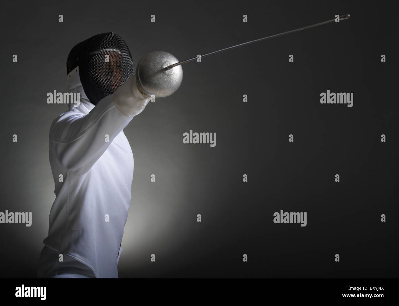 Studio portrait of fencer holding fencing foil Stock Photo - Alamy