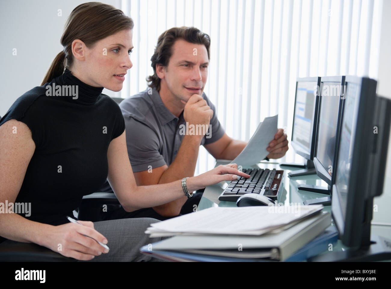 Man and woman working with computers Stock Photo - Alamy