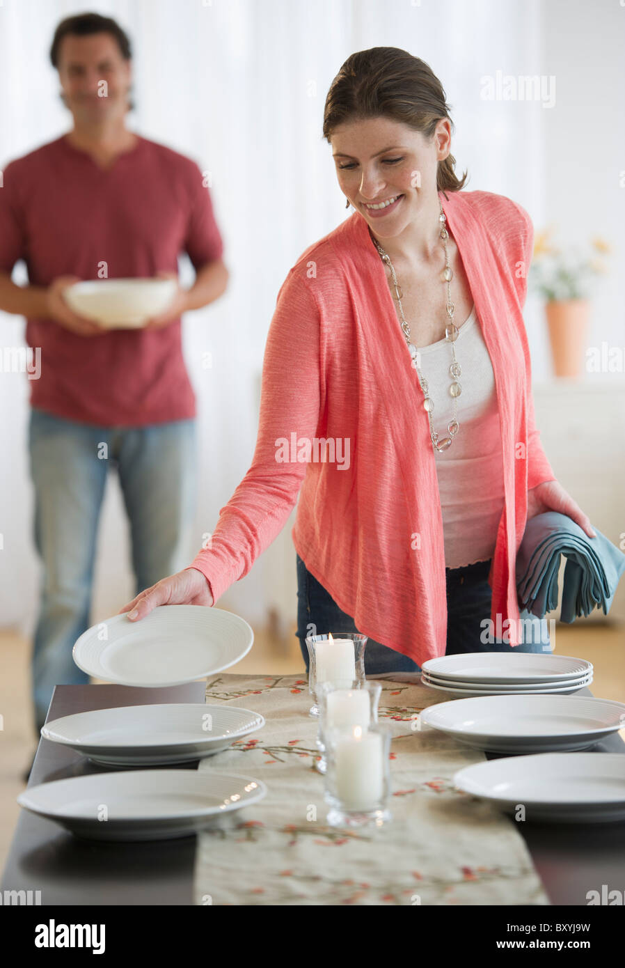 Couple preparing table Stock Photo - Alamy
