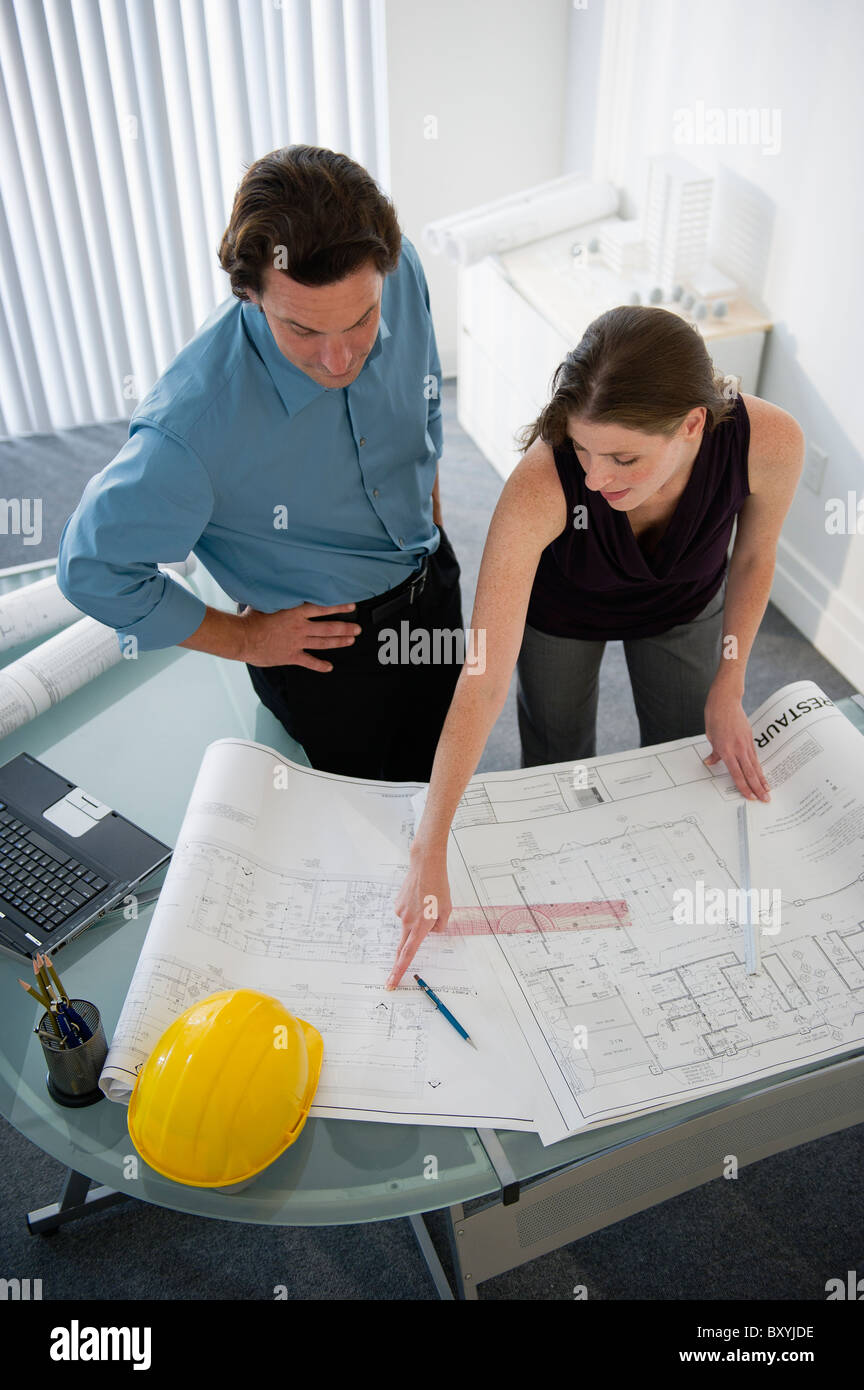 Architects with blueprints in office Stock Photo - Alamy