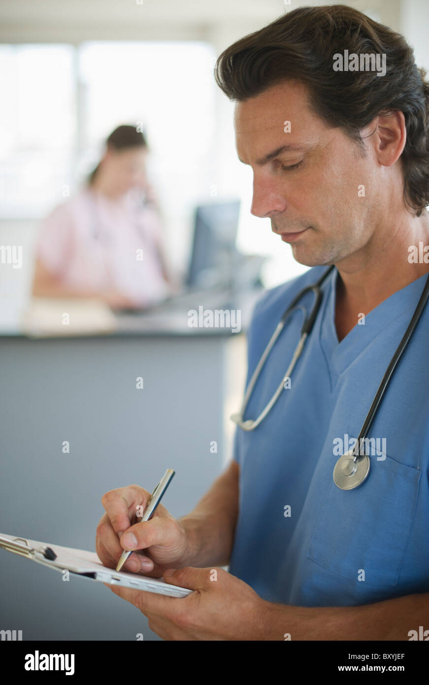 Doctor writing documentation in hospital Stock Photo - Alamy