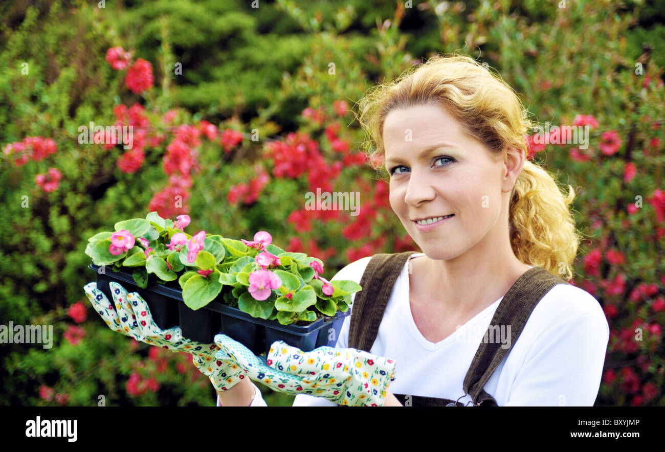Young woman with container-grown plants - gardening Stock Photo - Alamy