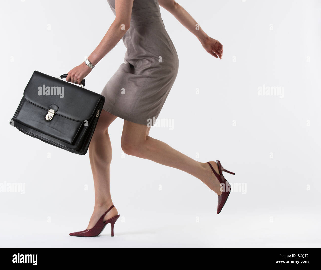 Young woman with briefcase, studio shot Stock Photo - Alamy