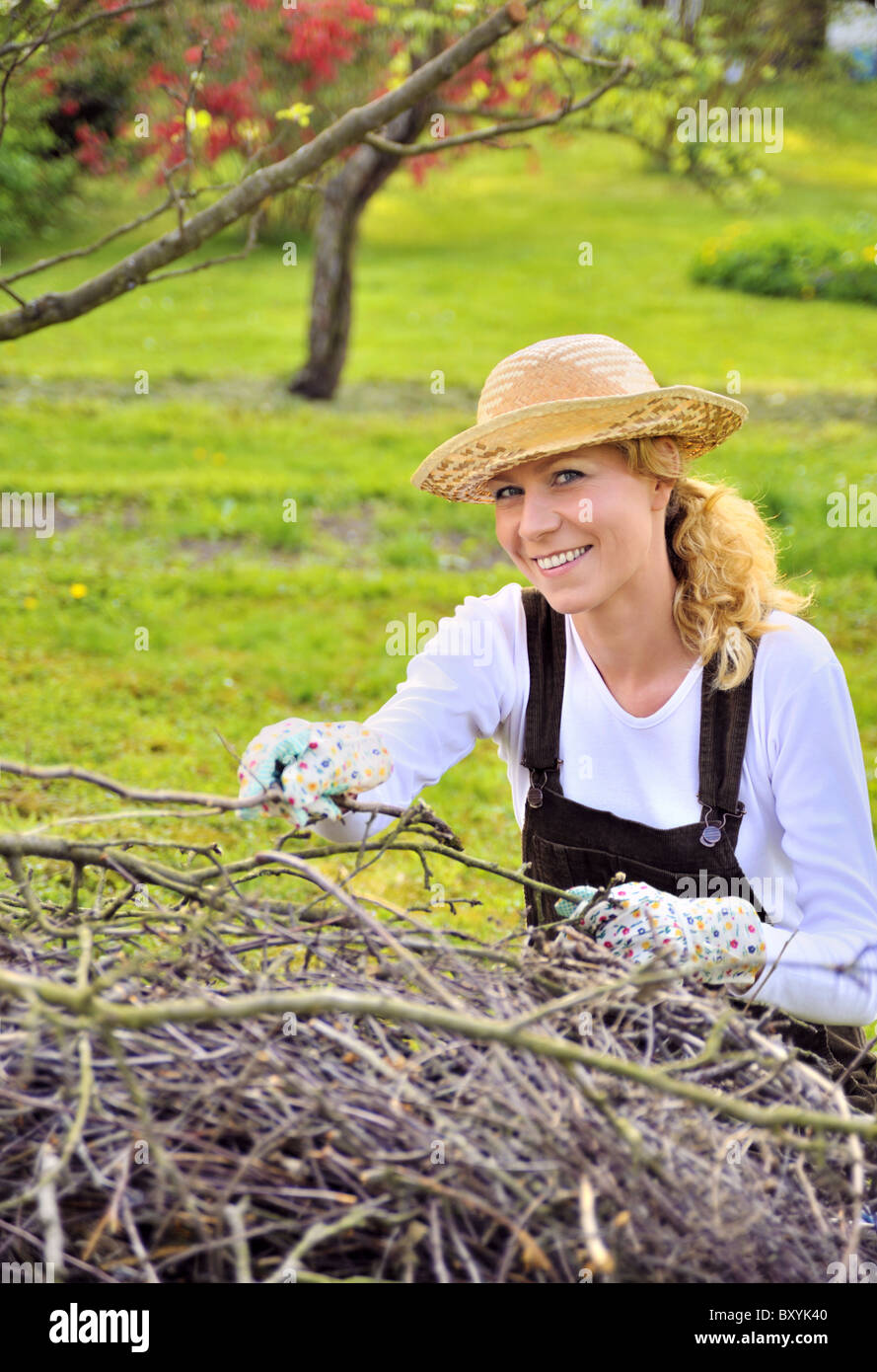 Young woman cleaning tree limbs Stock Photo - Alamy