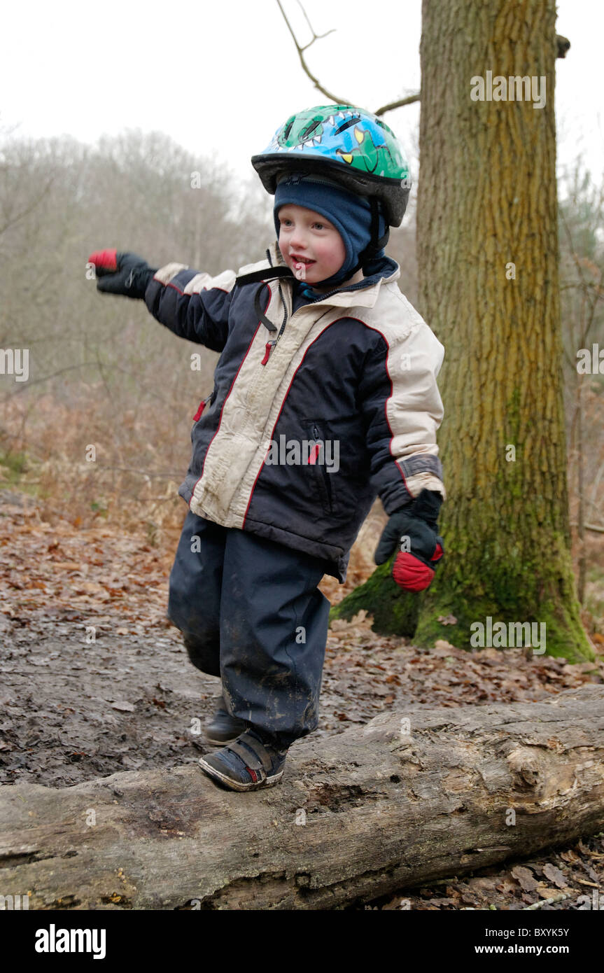 A boy balancing along a fallen tree Stock Photo - Alamy