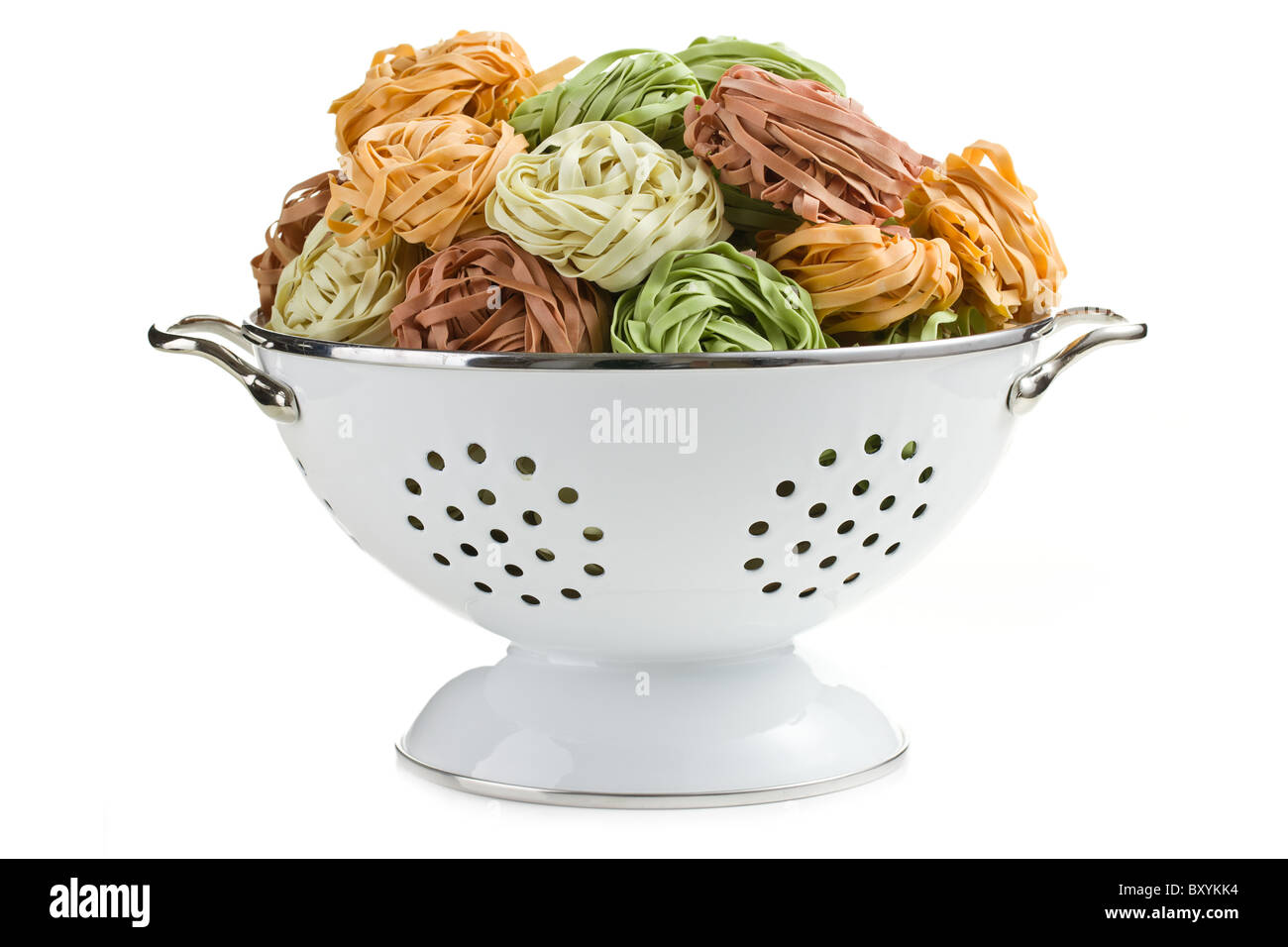 pasta tagliatelle in colander on white background Stock Photo - Alamy