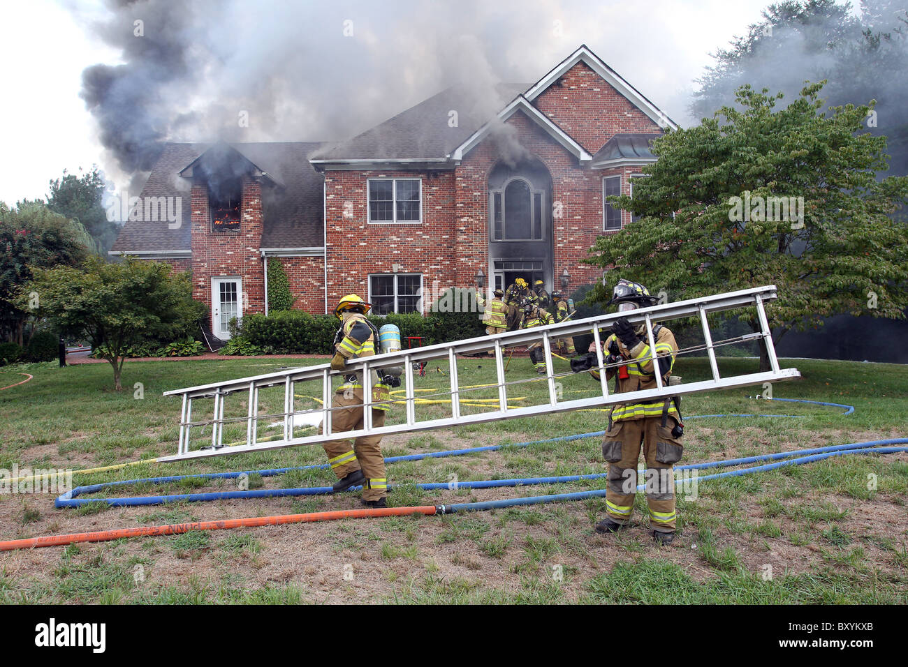 Fire fighters put out a blaze in a 2 story house Stock Photo - Alamy