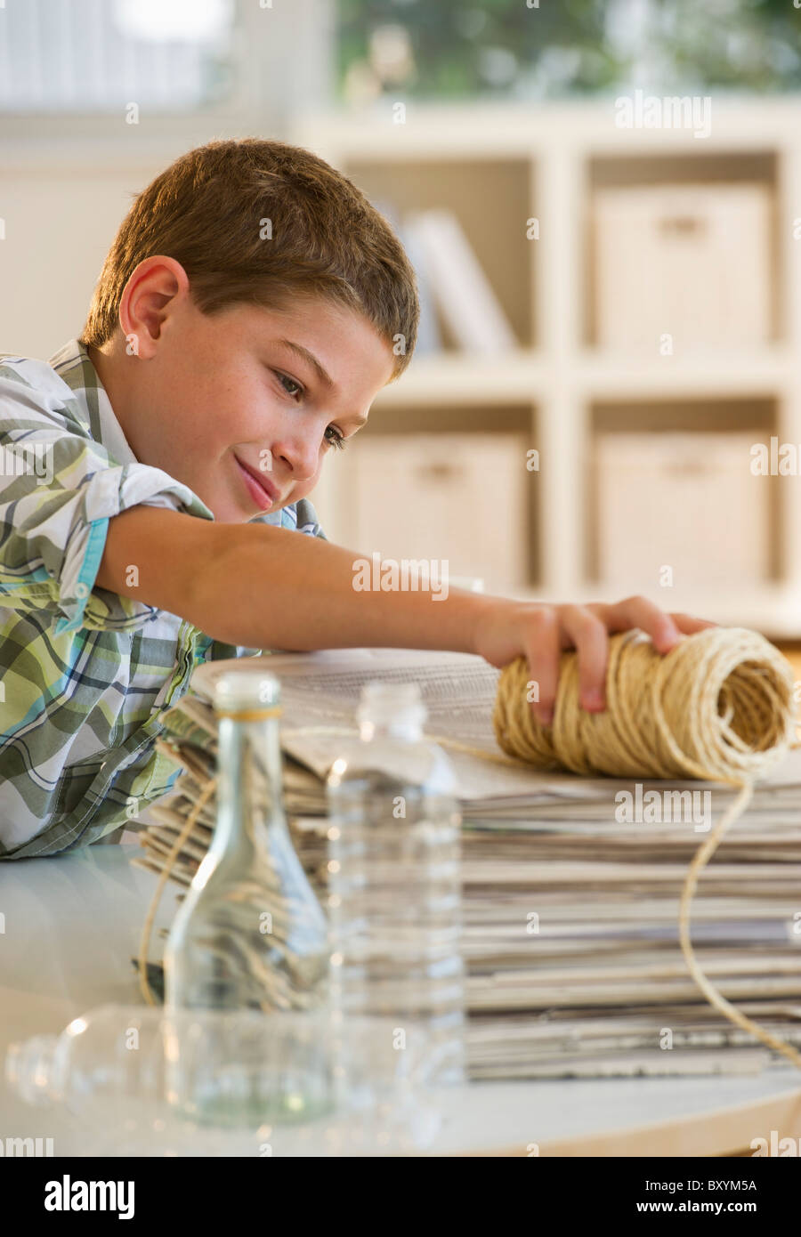 Boy sorting garbage at home Stock Photo - Alamy