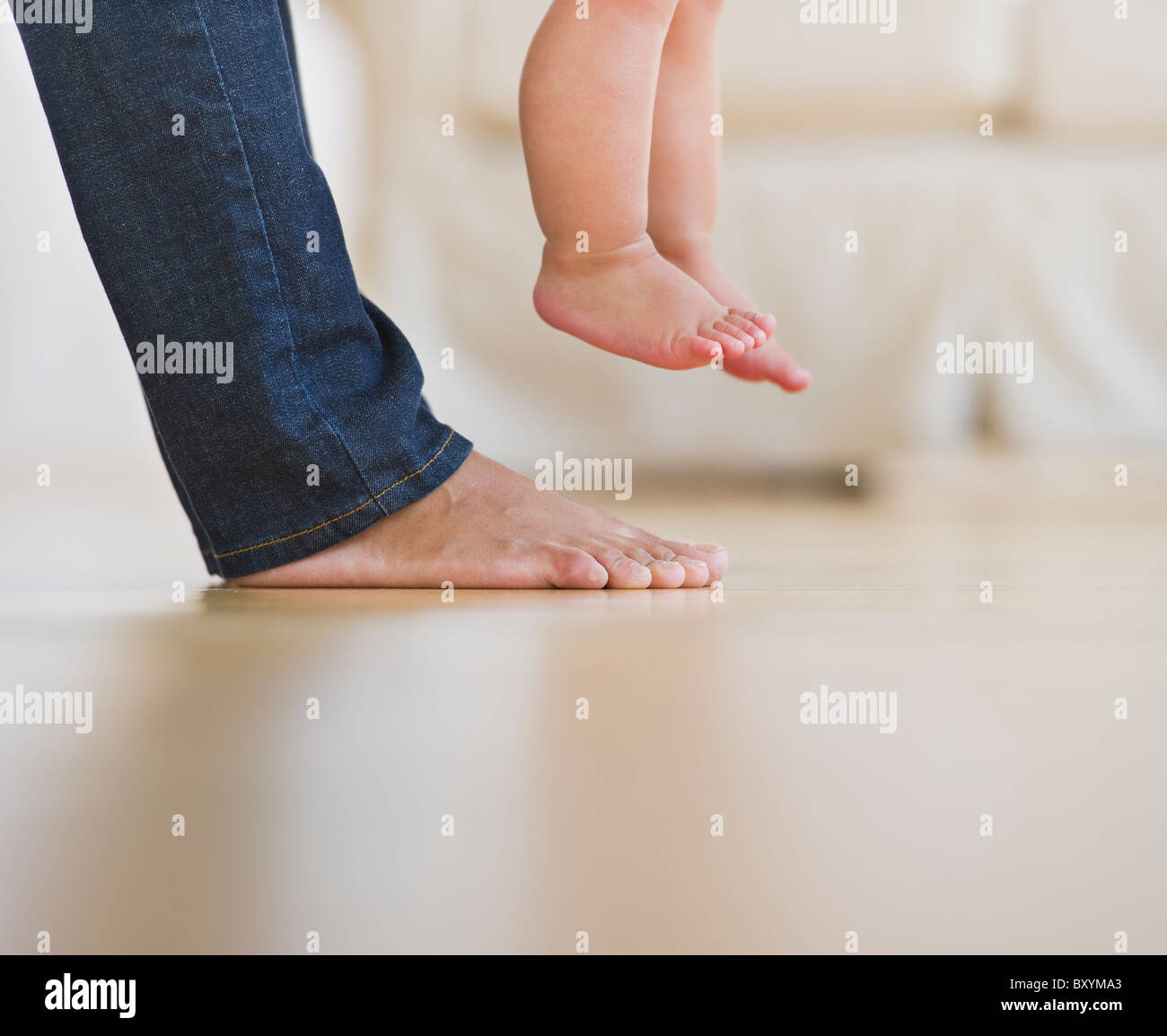 Mother carrying son, low section Stock Photo - Alamy