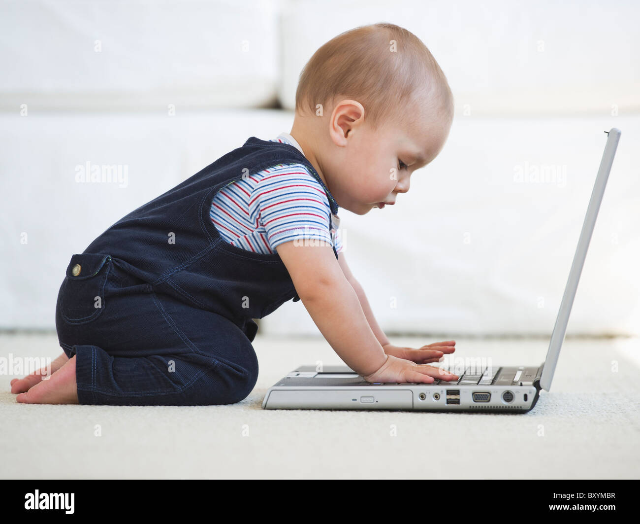 Baby boy using laptop Stock Photo - Alamy