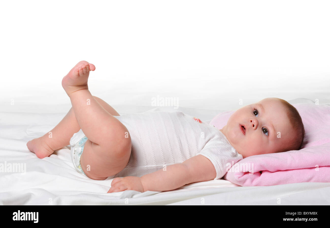 The baby lays. Age of 8 months. It is isolated on a white background ...