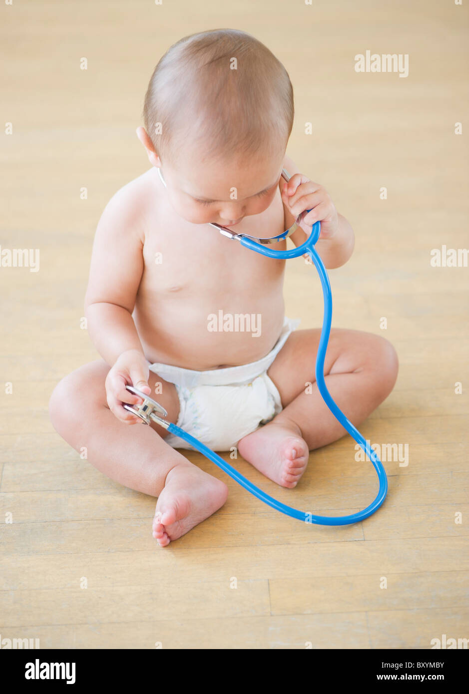 Baby boy playing with stethoscope Stock Photo - Alamy