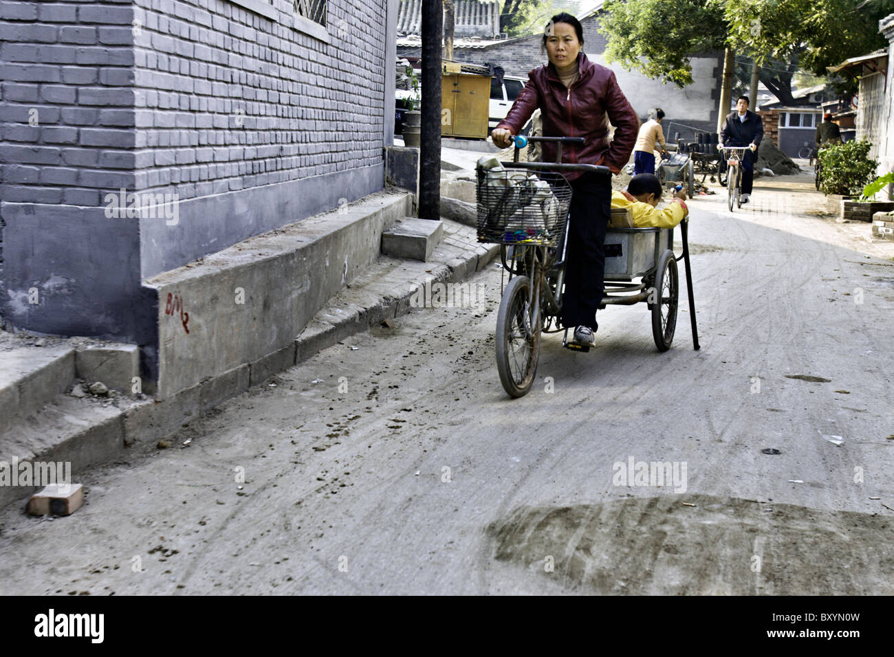 CHINA, BEIJING: Chinese woman pedaling her three-wheeled bicycle ...