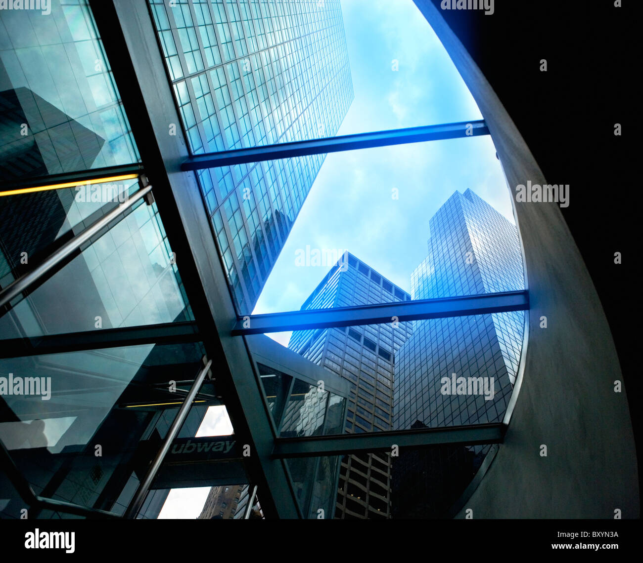 Tall skyscrapers seen through glass ceiling of modern office building ...