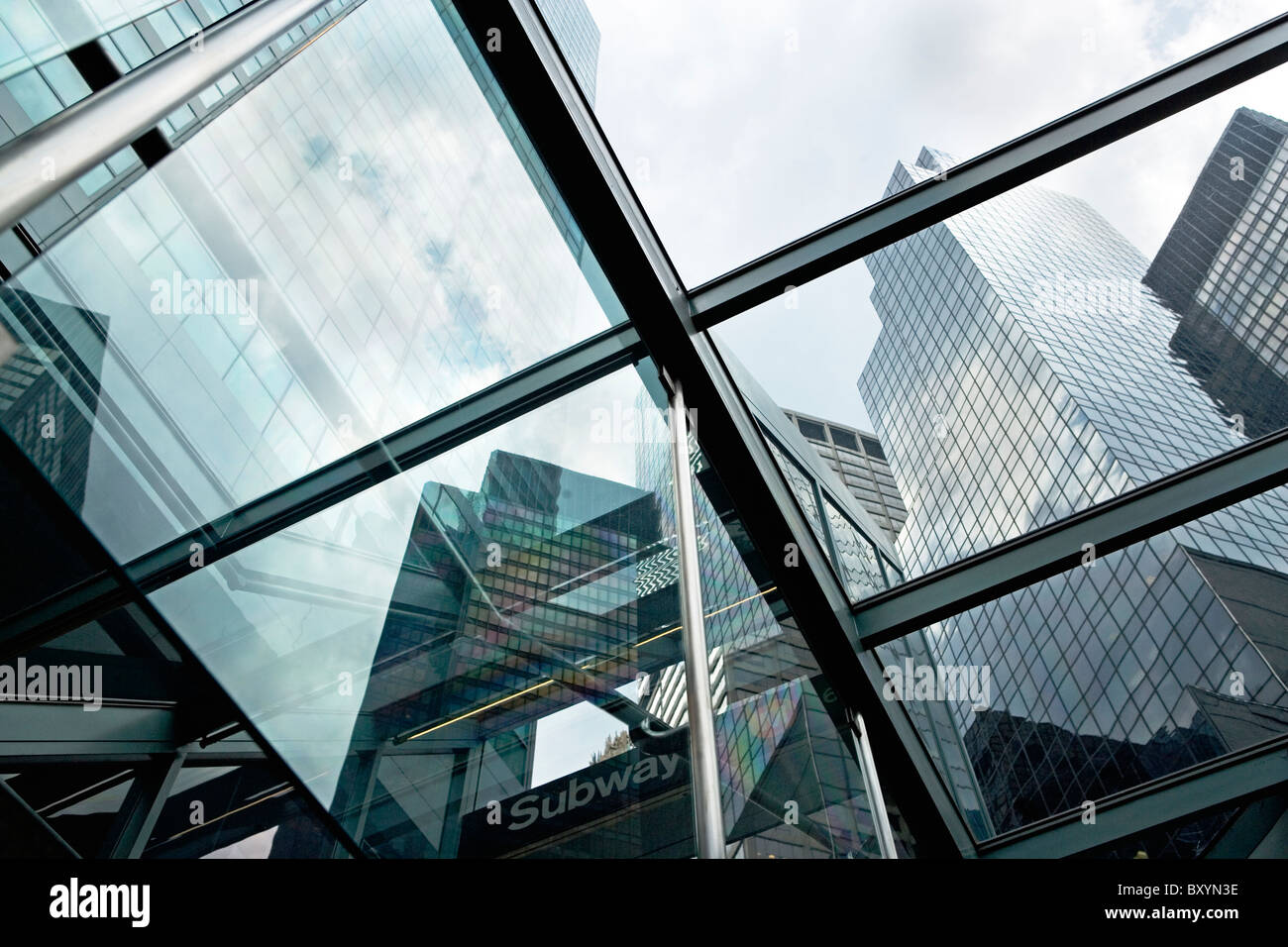 Tall skyscrapers seen through glass ceiling of modern office building ...
