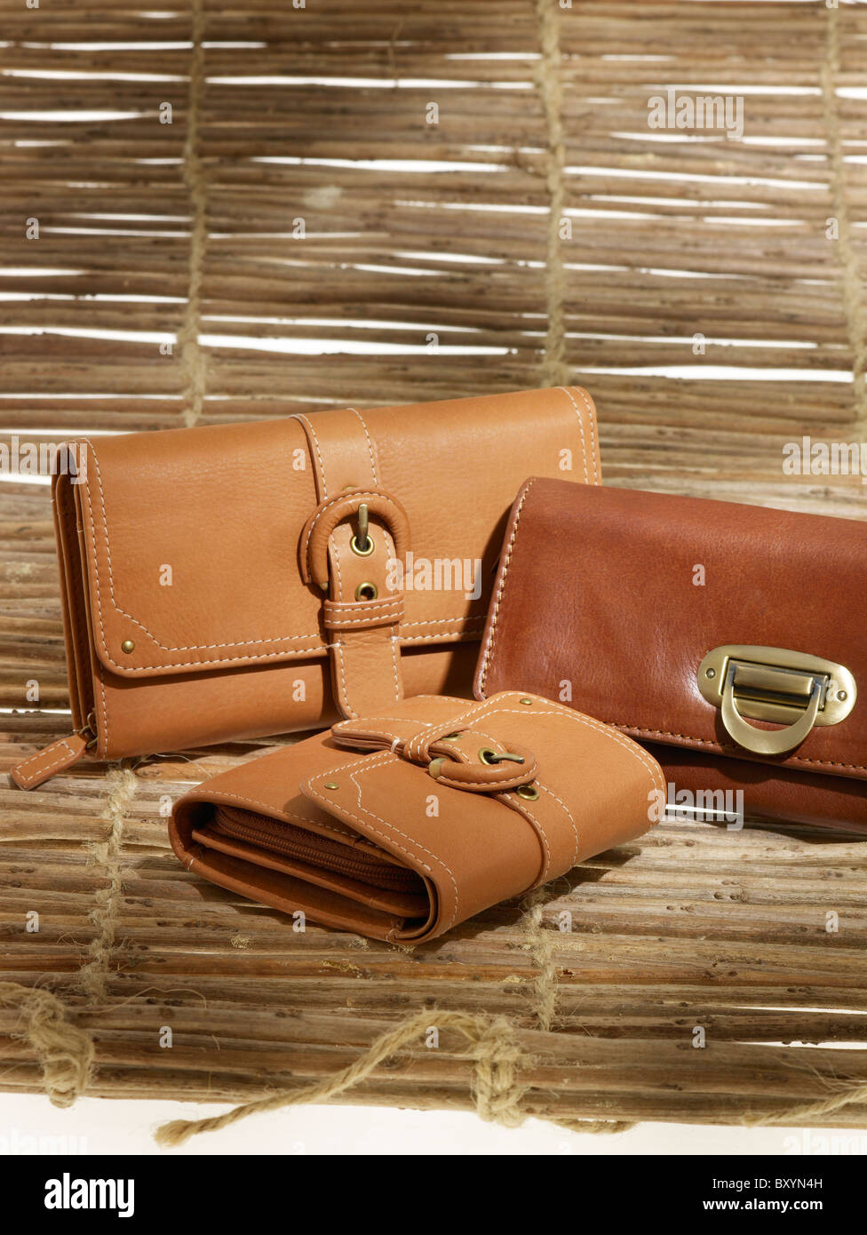 brown tan ladies purses on rafia background Stock Photo - Alamy