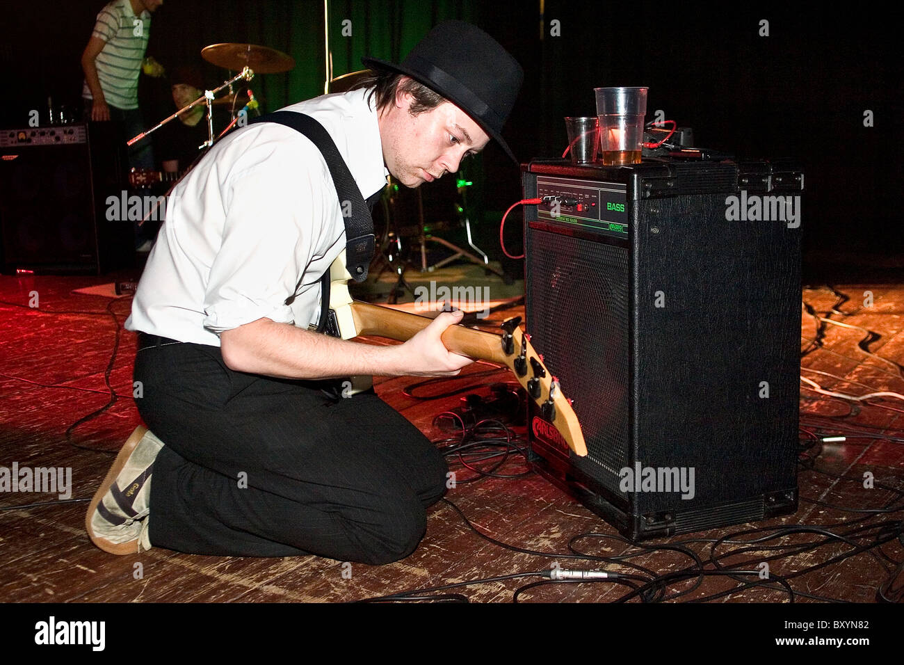 A guitarist tunes his guitar on stage before a pop concert in the UK ...