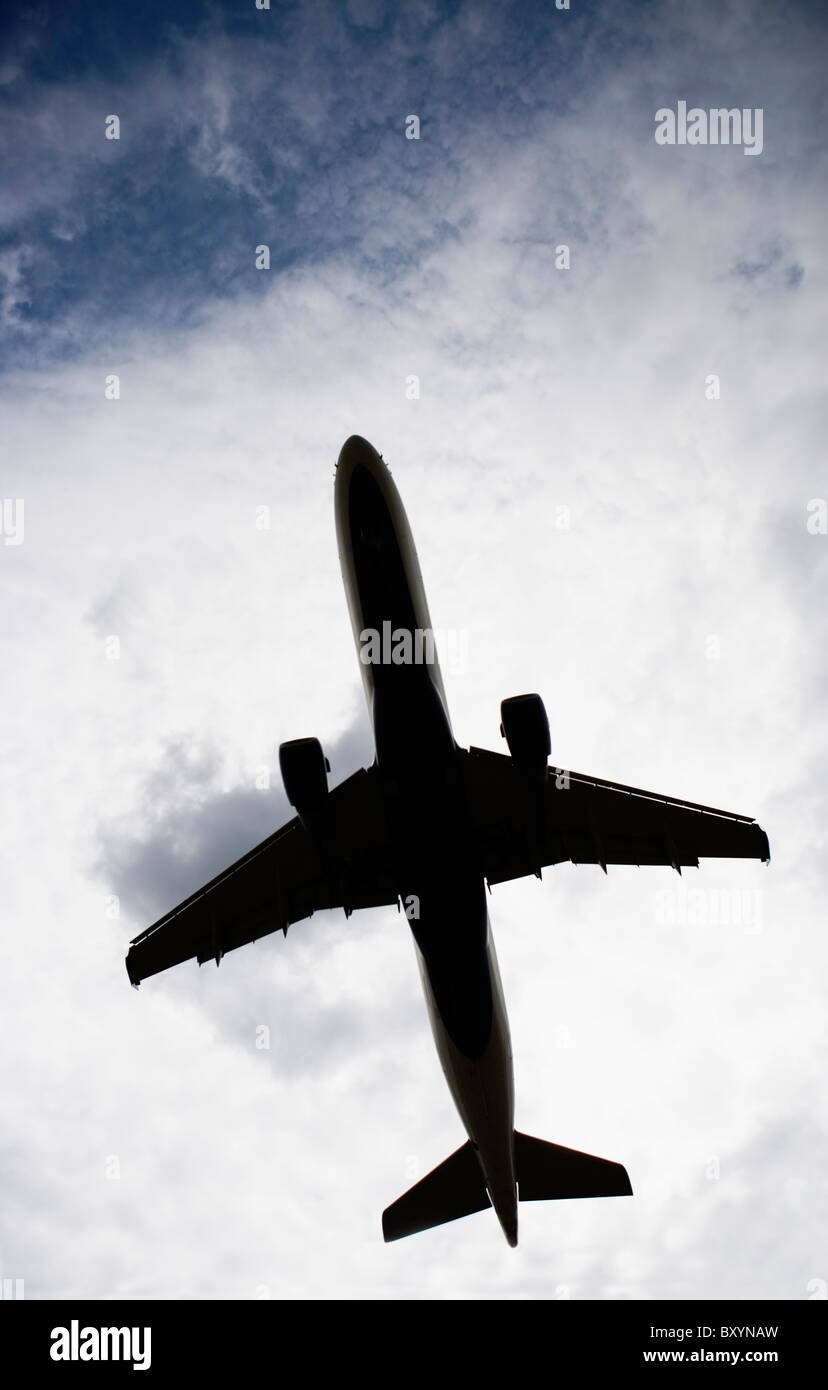 Silhouette of flying airplane Stock Photo - Alamy