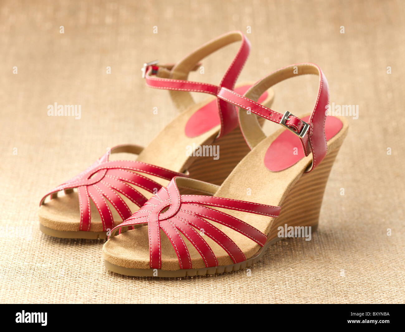 pair of red womens shoes sandals on a raffia background Stock Photo - Alamy