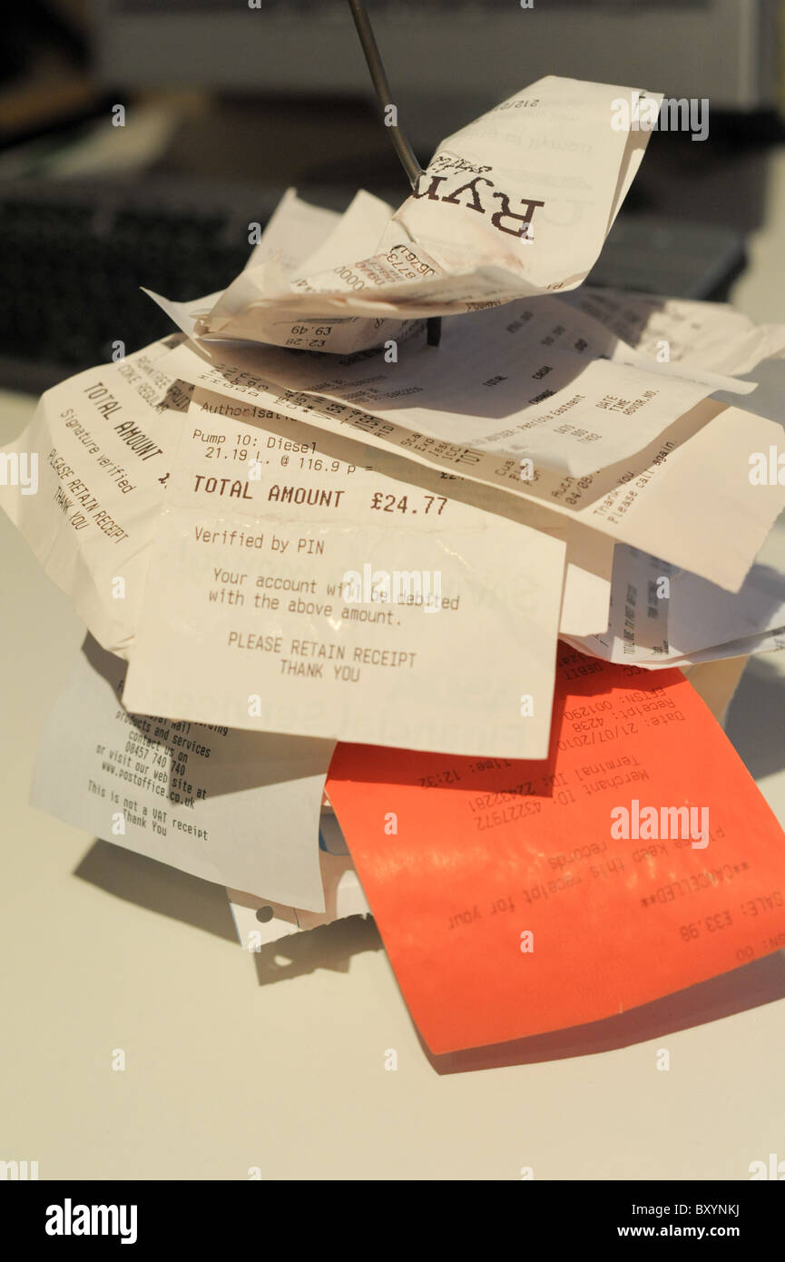 Receipts and bills on a spike in an office ready for expenses accounts ...
