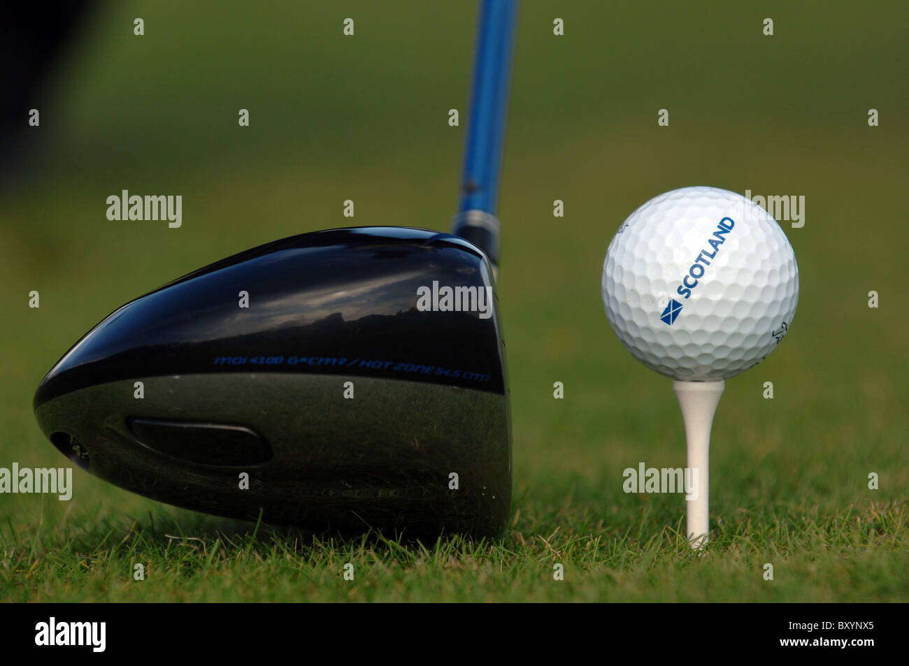 Golf club and tee Stock Photo - Alamy