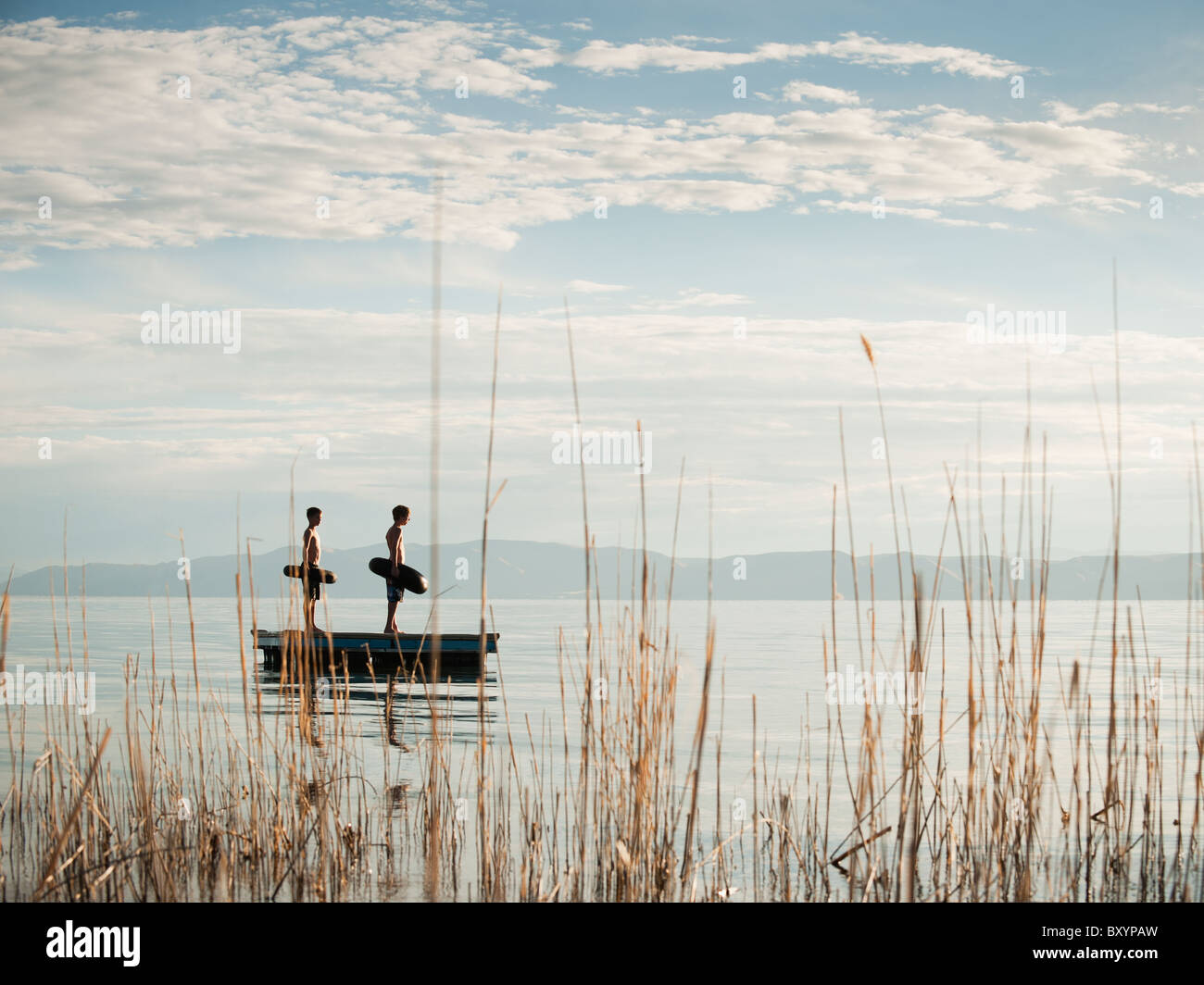 Boys jumping from raft Stock Photo - Alamy