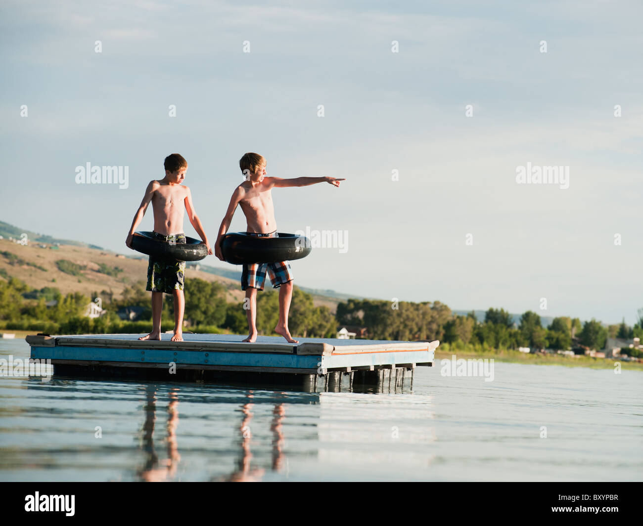 Boys jumping from raft Stock Photo - Alamy