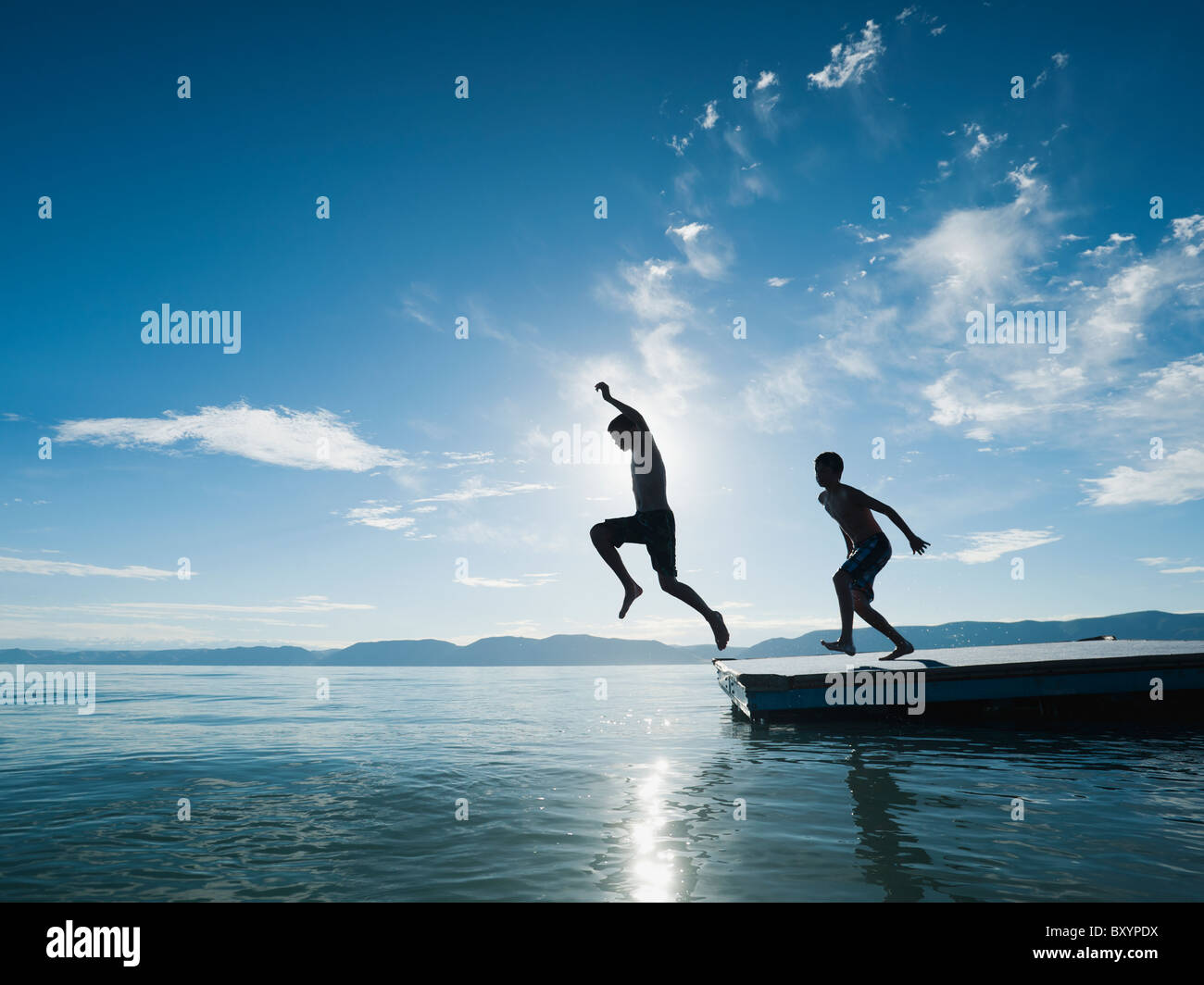 Children jumping into water silhouette hi-res stock photography and ...