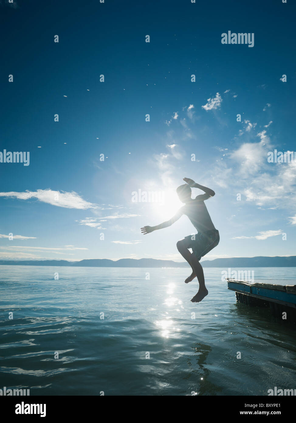 Children jumping into water silhouette hi-res stock photography and ...