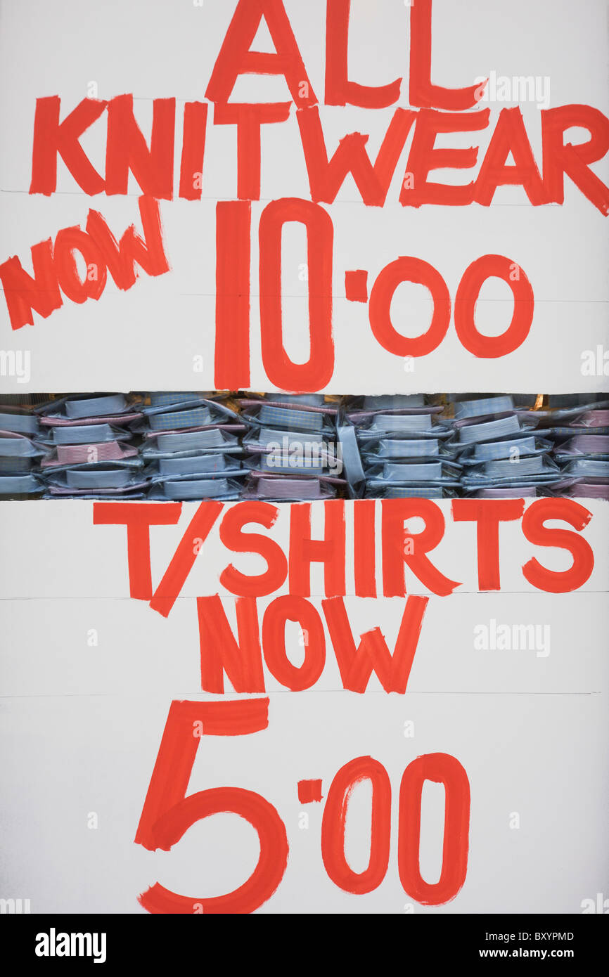 Sale price of £10 Pounds for t-shirts with shirts in window of city ...