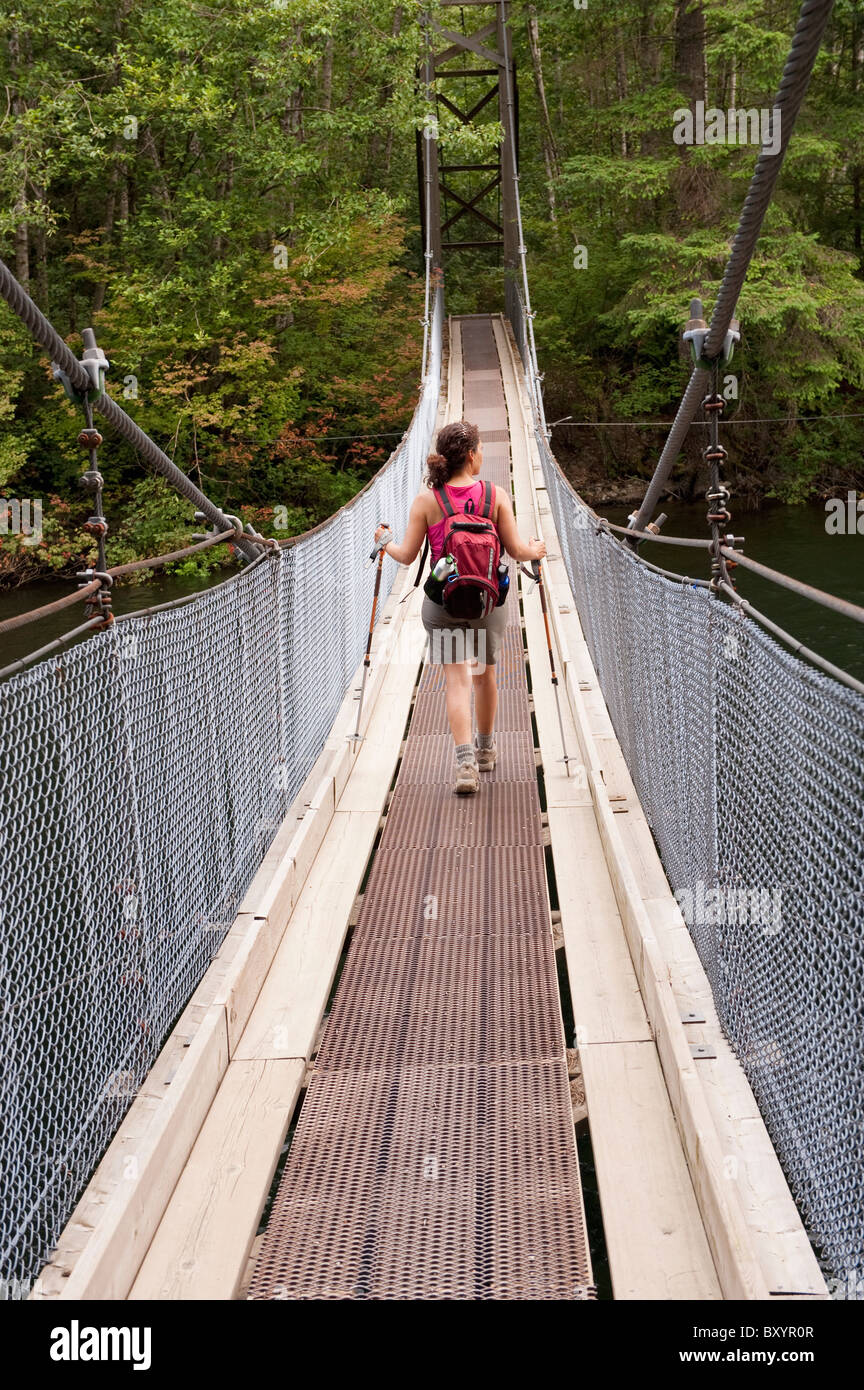 Woman walking over suspension bridge hi-res stock photography and ...